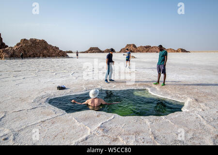 Water of Lake Karum, visible through a hole in the salt flat, Danakil ...