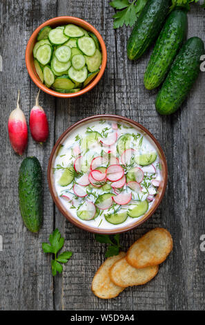 top view of fresh cold summer cocktails in glasses on wooden table ...