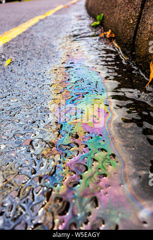 Spilt Petrol Gasoline Oil Running Down a Drain On a Road Gutter ...