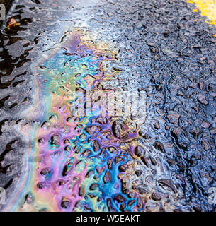 Spilt Petrol Gasoline Oil Running Down a Drain On a Road Gutter ...