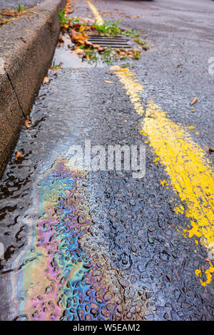 Spilt Petrol Gasoline Oil Running Down a Drain On a Road Gutter ...