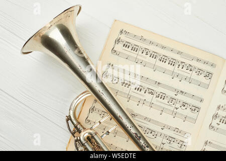 Trumpet on musical notes close up. Musical background with old trumpet ...