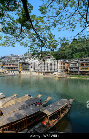 Hunan, China - Nov 6, 2015. Wooden boats on the main canal at Fenghuang ...