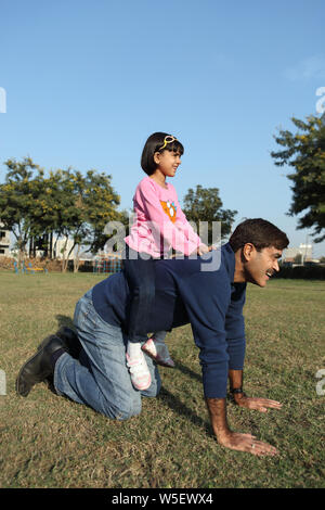 Old man crawling with granddaughter on back in a park Stock Photo - Alamy