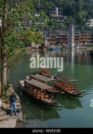 Hunan, China - Nov 6, 2015. Wooden boats on the main canal at Fenghuang ...