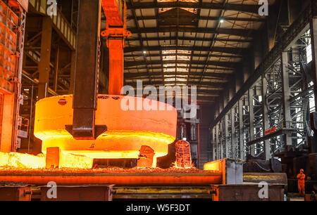 --FILE--Chinese workers check a seamless forging piece at a forging ...