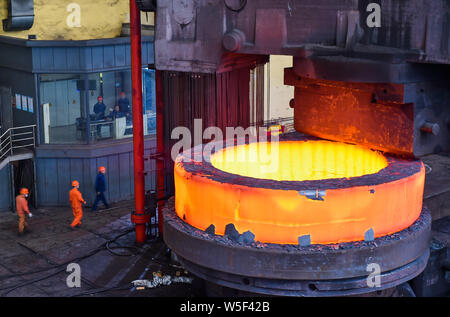 --FILE--Chinese workers check a seamless forging piece at a forging ...