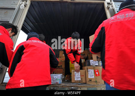 Chinese couriers of an express delivery company sort out parcels from ...