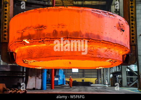 --FILE--Chinese workers check a seamless forging piece at a forging ...
