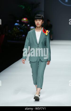 A model displays a new creation at the Qiu Yuwen & Zhang Zhaoda Fashion ...