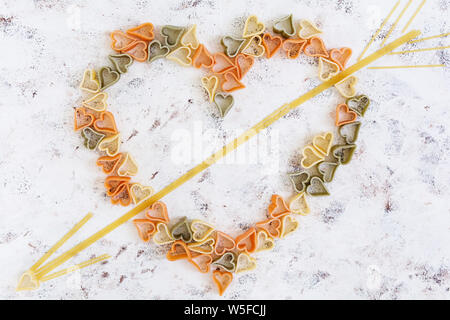 Colorful dry love pasta on dark background. Top view Stock Photo - Alamy