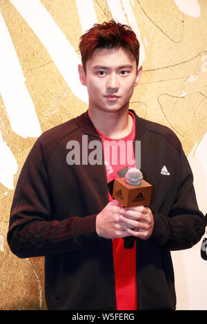 Chinese world swimming champion Ning Zetao holds his trophy for the ...