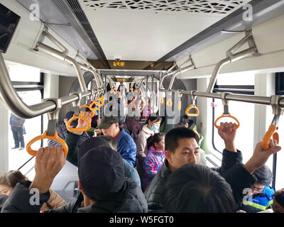 Passengers take a railless train, developed by the CRRC Zhuzhou ...