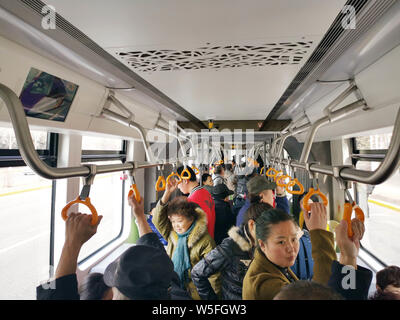 Passengers take a railless train, developed by the CRRC Zhuzhou ...