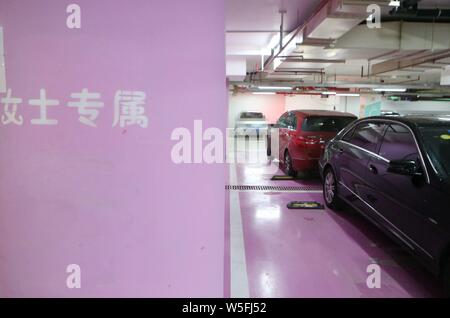 View of pink parking spaces for female drivers in the parking lot of a ...
