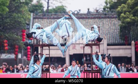 People attend the opening ceremony of the Boluo Dan Temple Fair ...
