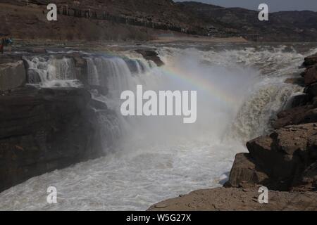 Landscape of a rainbow over the Hukou Waterfall of the Yellow River in ...