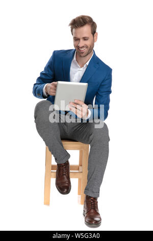 laughing blonde with a tablet in hands on a white background Stock ...