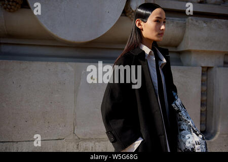 A trendy woman poses for street snaps during the Paris Fashion Week ...