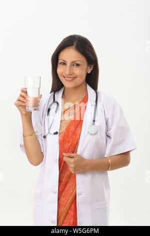 Indian female doctor holding a glass of orange juice Stock Photo - Alamy
