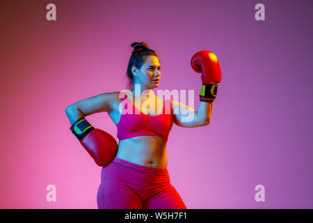 Woman in boxing gloves lifting her arms Stock Photo - Alamy