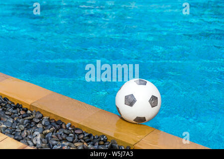 Soccer ball floating in the swimming pool Stock Photo - Alamy
