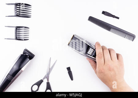 machine for haircuts. On the table are scissors and a comb. Barbershop ...