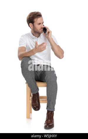 confused man talking on cell phone isolated on white background Stock ...