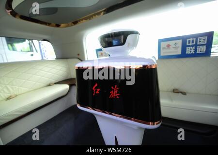 A FAW Hongqi or Red Flag unmanned 5G minibus is parked during an expo ...
