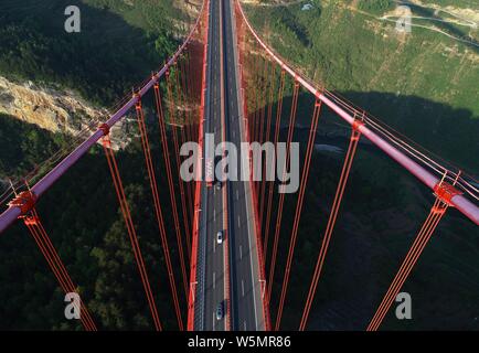 Cars drive on the Qingshui River Bridge, which is third highest ...