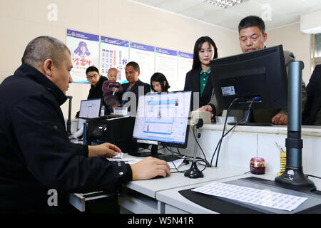 Chinese residents apply for passports at a branch of local exit and ...