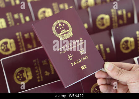 A Chinese policeman shows passports at a branch of local exit and entry ...