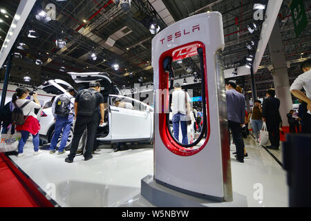 --FILE--People visit the stand of Tesla during an exhibition in ...