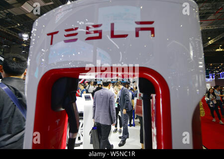 --FILE--People visit the stand of Tesla during an exhibition in ...