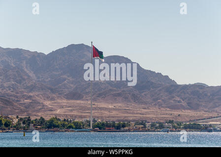 Aqaba, Jordan - November 6, 2017: Flag of Jordan waving over the city ...