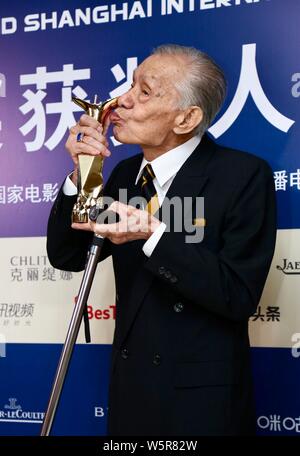 96-year-old Chinese actor Chang Feng poses with his trophy after ...