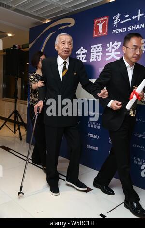 96-year-old Chinese actor Chang Feng poses with his trophy after ...