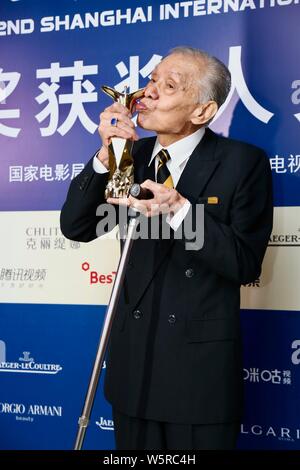 96-year-old Chinese actor Chang Feng poses with his trophy after ...