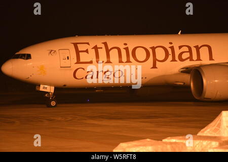Ethiopian Cargo Boeing 777-200F aircraft flying. Freighter airplane of Ethiopian Cargo inbound ...