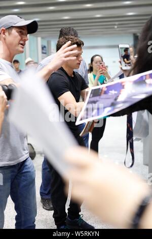 English actor Tom Holland signs autographs for fans as he arrives on ...