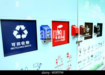 Local residents use QR code cards to open different bins to put their ...