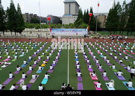Thousands of Chinese yoga lovers practice yoga to mark the upcoming ...