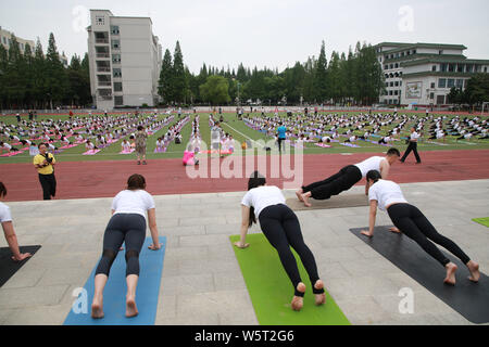 Thousands of Chinese yoga lovers practice yoga to mark the upcoming ...