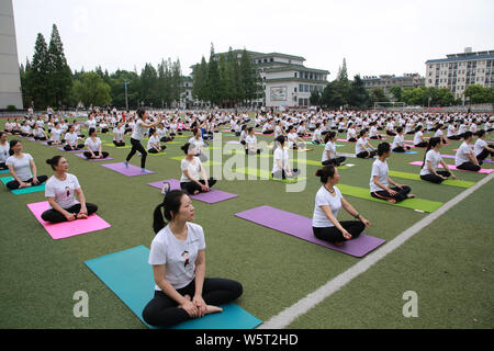 Thousands of Chinese yoga lovers practice yoga to mark the upcoming ...