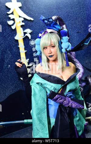 An entertainer dressed in cosplay costume poses during the Shanghai ...