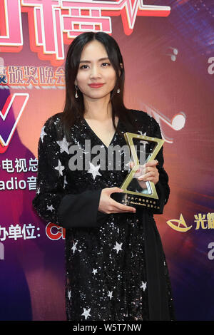 Chinese singer Liu Xijun poses with her trophy during the 2018 Music ...