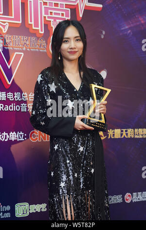 Chinese singer Liu Xijun poses with her trophy during the 2018 Music ...