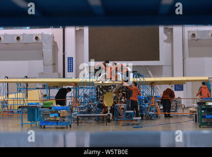 --FILE--Chinese workers assemble a Wing Loong unmanned aerial vehicle ...