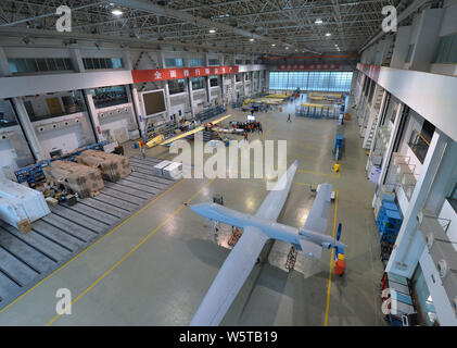 --FILE--Chinese workers assemble a Wing Loong unmanned aerial vehicle ...