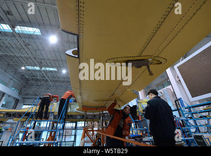 --FILE--Chinese workers assemble a Wing Loong unmanned aerial vehicle ...